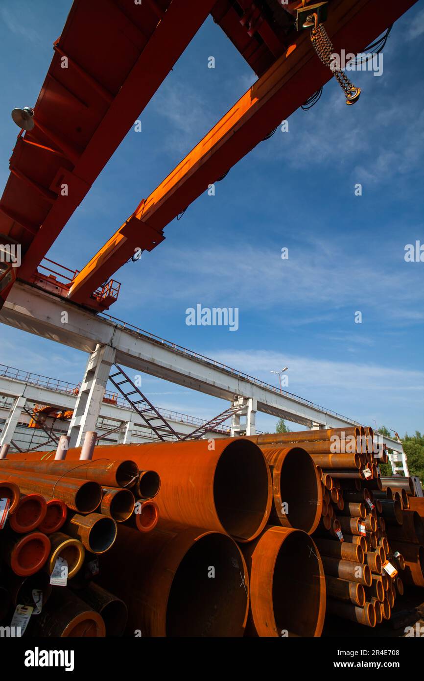 Rusted steel tubes on outdoor warehouse. Overhead crane up Stock Photo ...