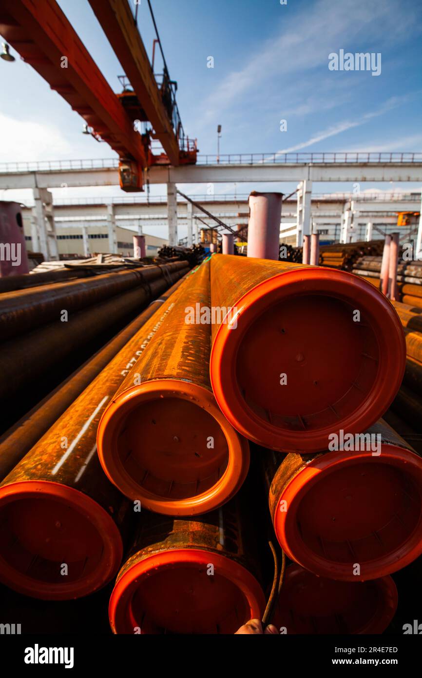 Rusted steel pipes with red plastic caps on outdoor warehouse Stock ...