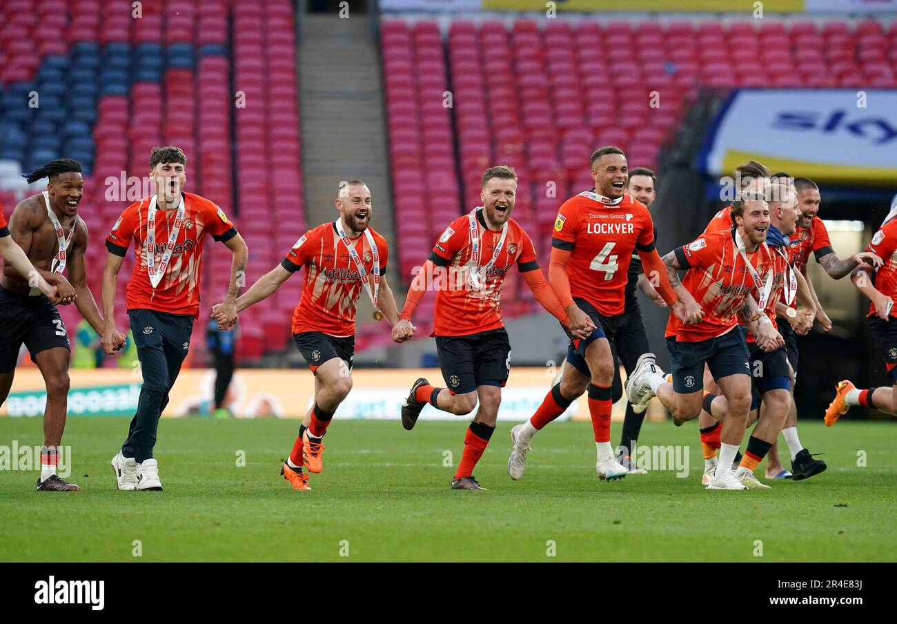 Luton Town players celebrate by running to the fans after winning ...