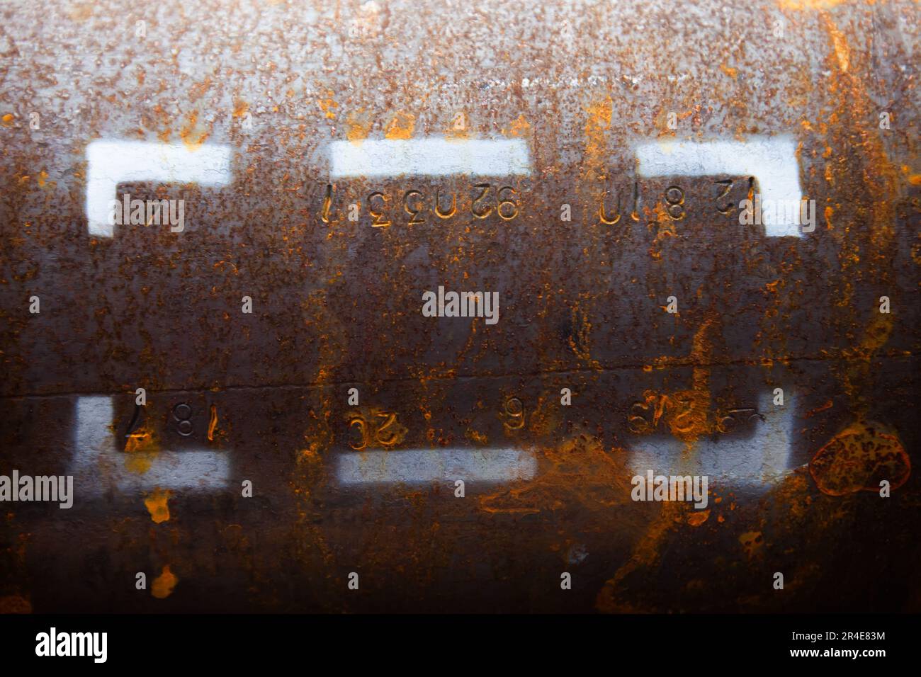 Marking of steel pipe. Close-up photo of embossed symbols on rusted ...