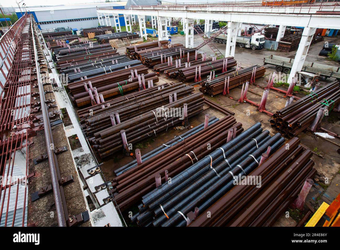Steel pipes outdoor warehouse. Wet metal in rainy day. View from ...