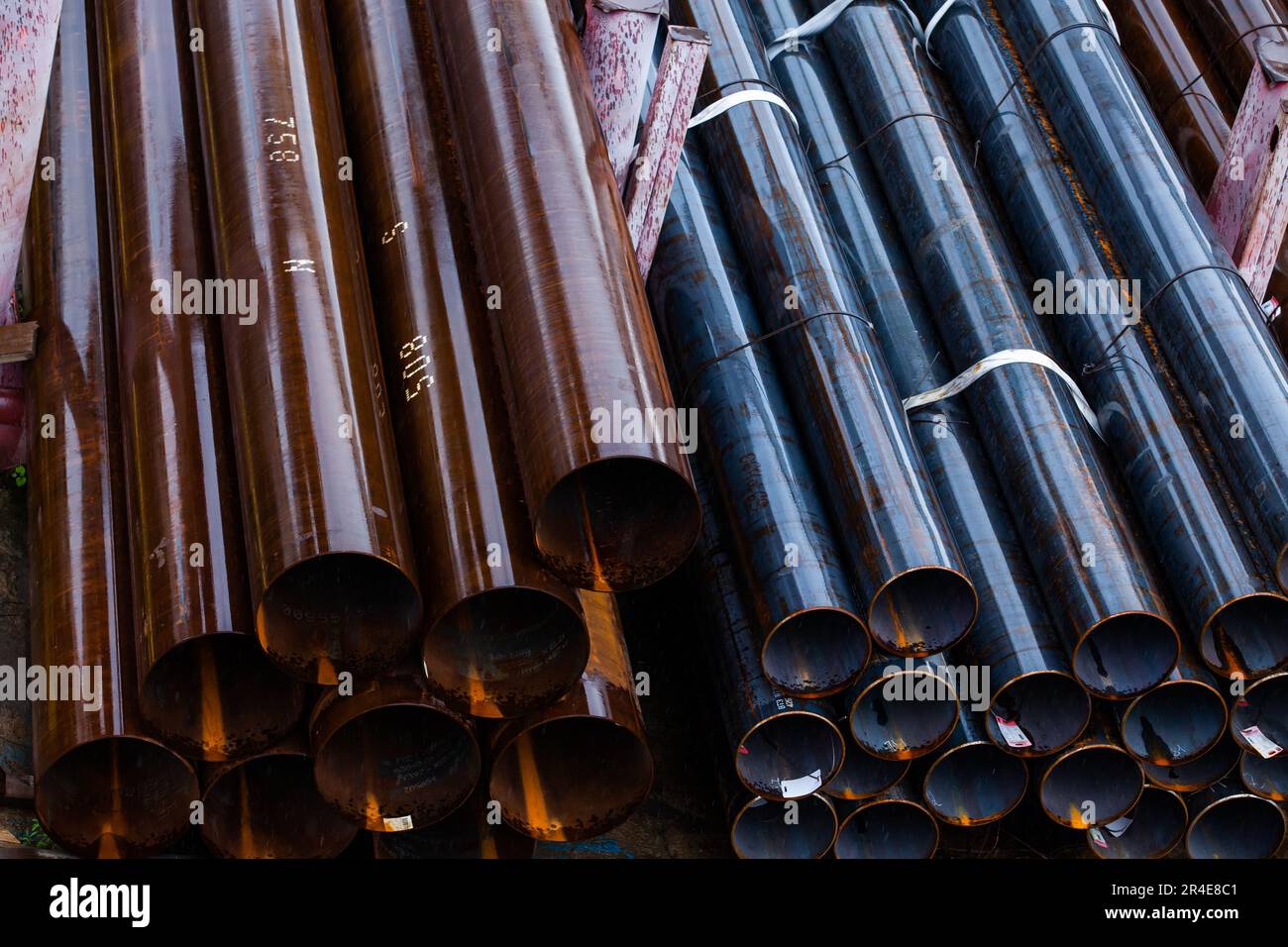 Steel pipes on outdoor warehouse. Wet tubes in rainy day Stock Photo ...