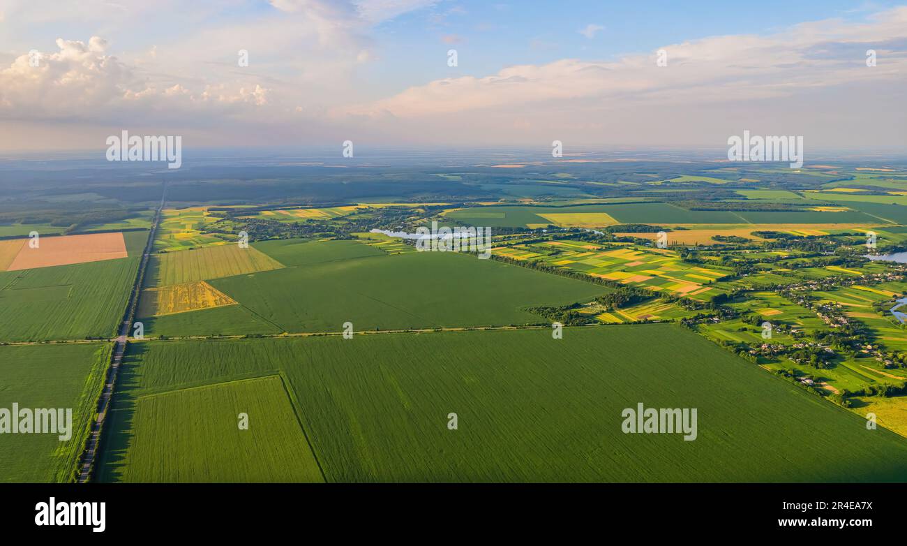Aerial view of wide river flowing quietly in rural countryside between ...
