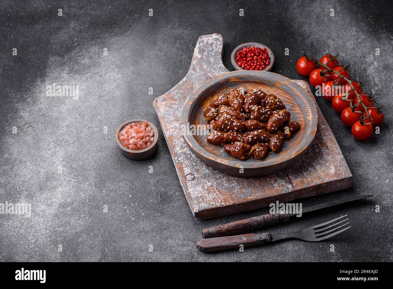 Chicken hearts fried in soy sauce with salt and spices in a plate on a ...