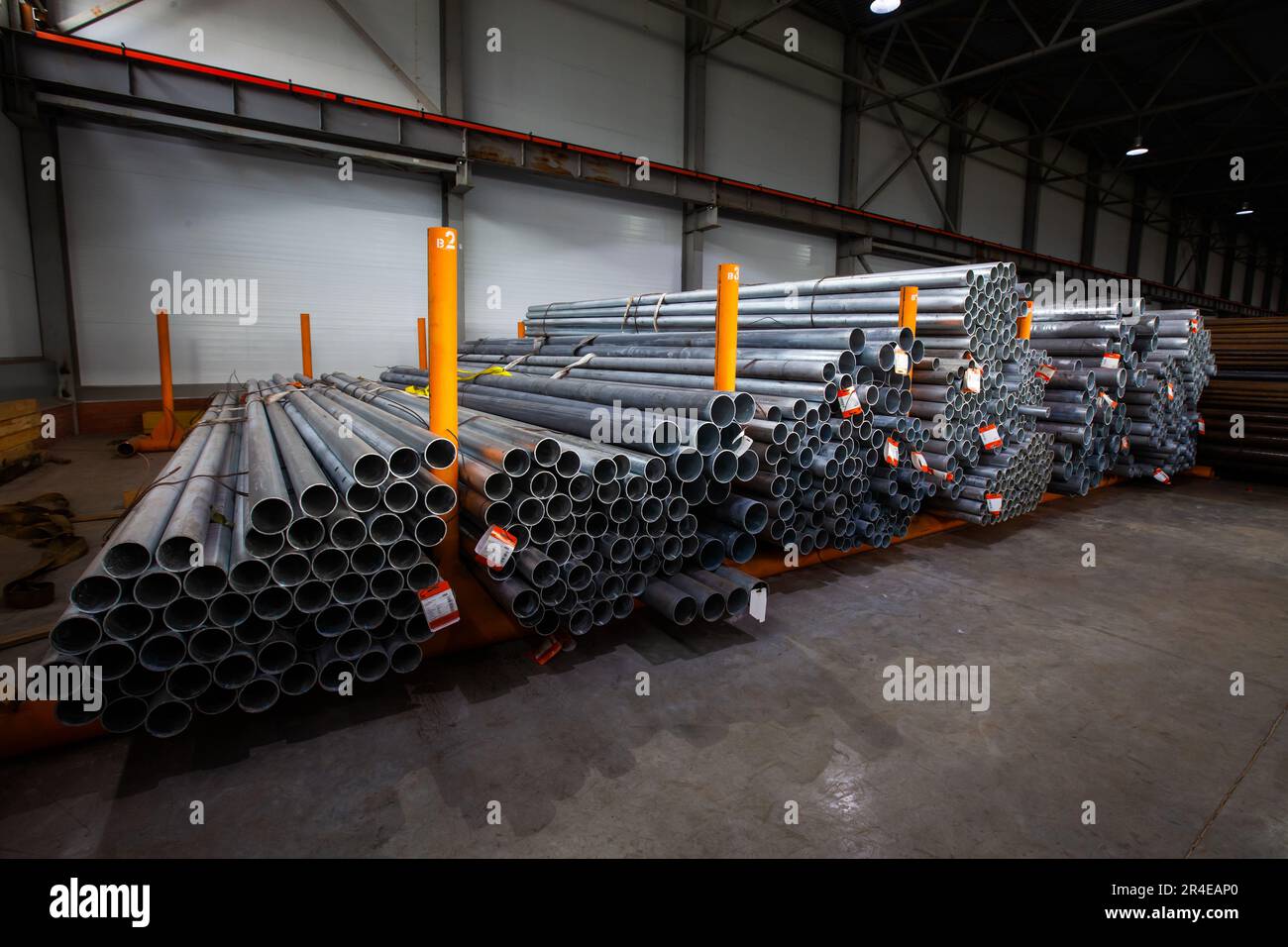 Steel pipes stack in metal hangar warehouse. panoramic view Stock Photo ...