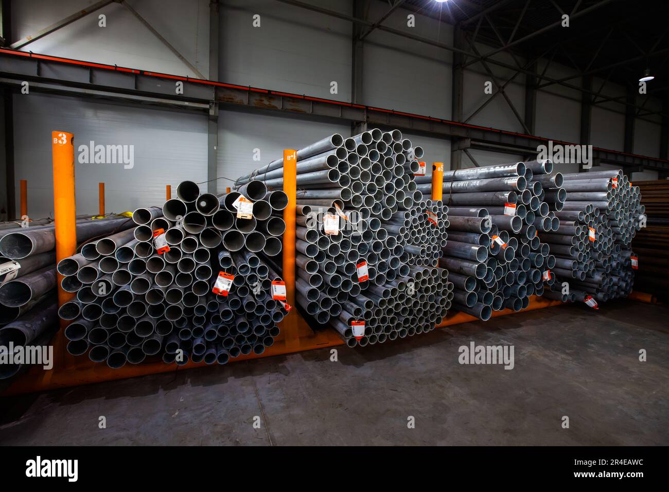 Pipes warehouse in metal hangar Stock Photo - Alamy