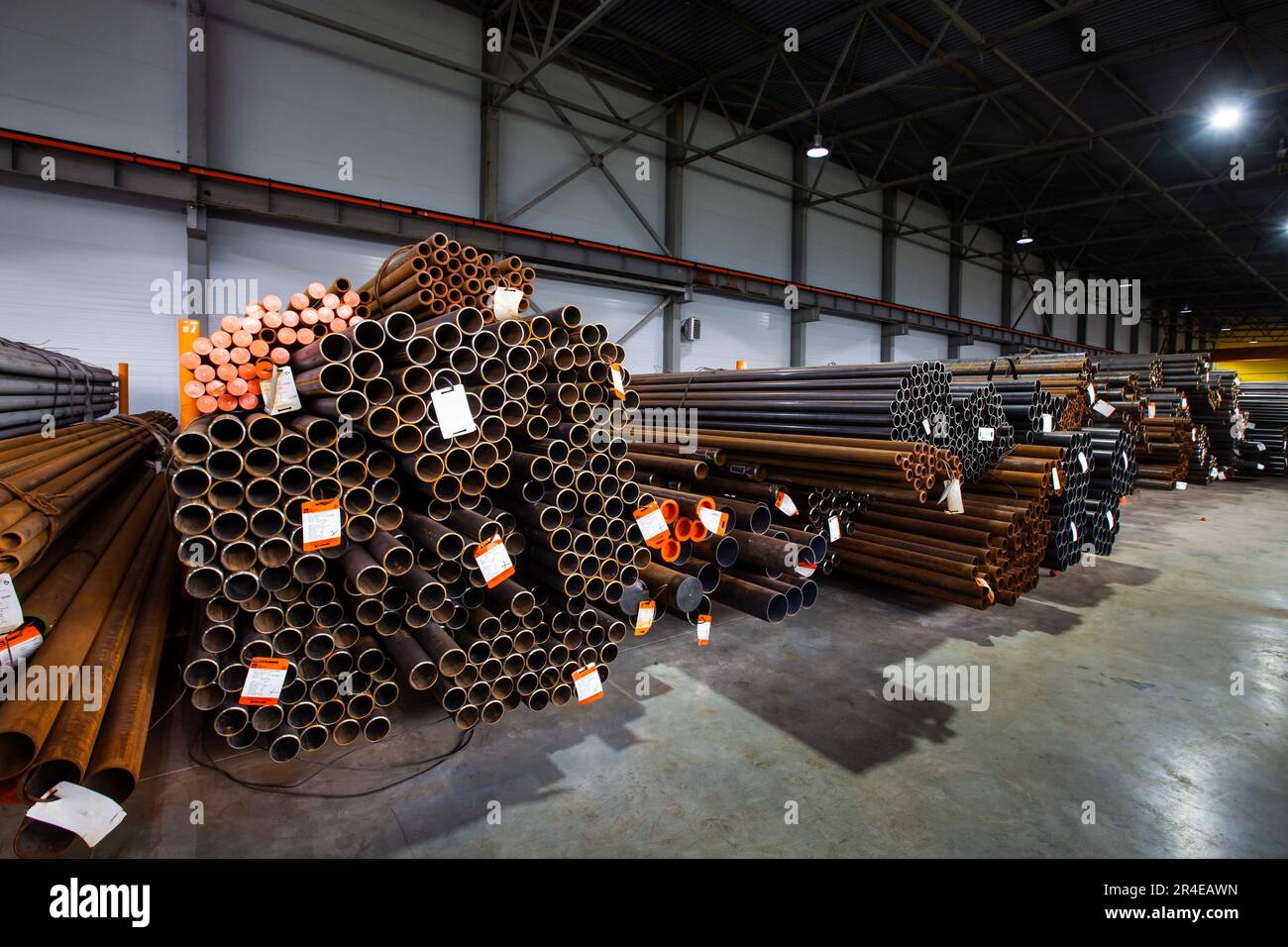 Pipes and tubes warehouse in metal hangar Stock Photo - Alamy