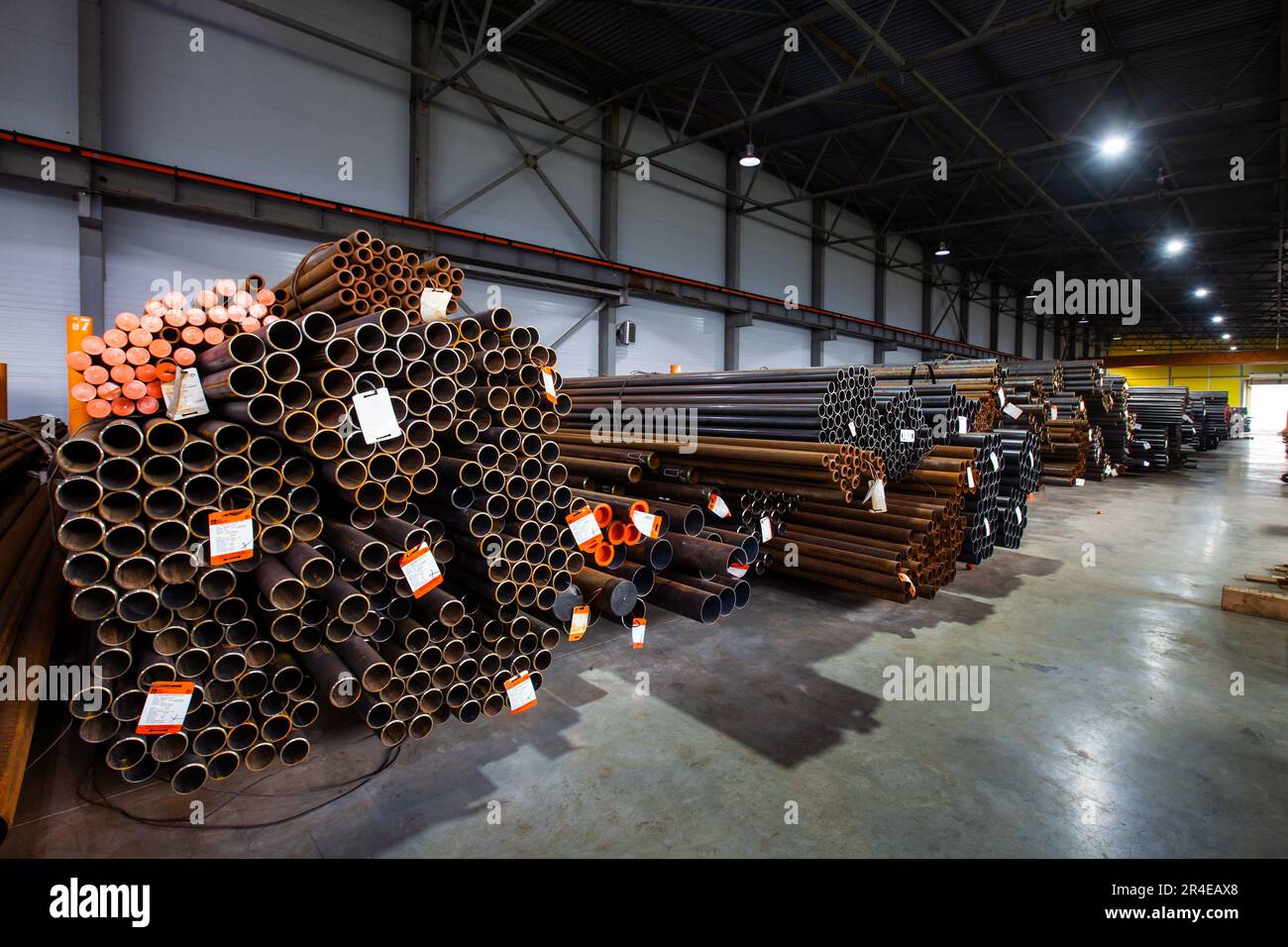 Pipes and tubes warehouse in metal hangar Stock Photo - Alamy