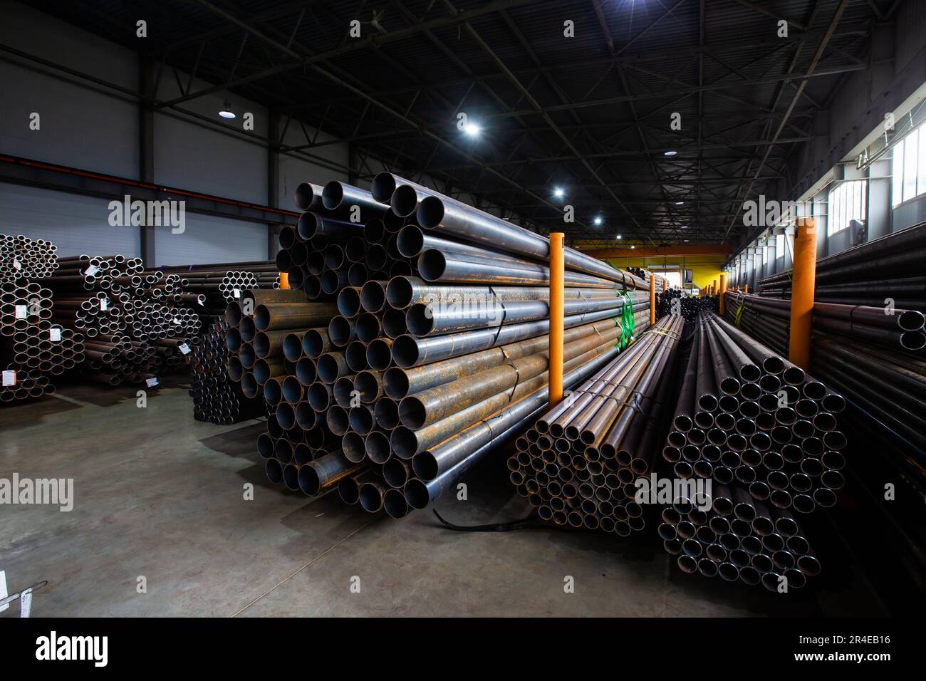 Pipes and tubes warehouse in metal hangar Stock Photo - Alamy