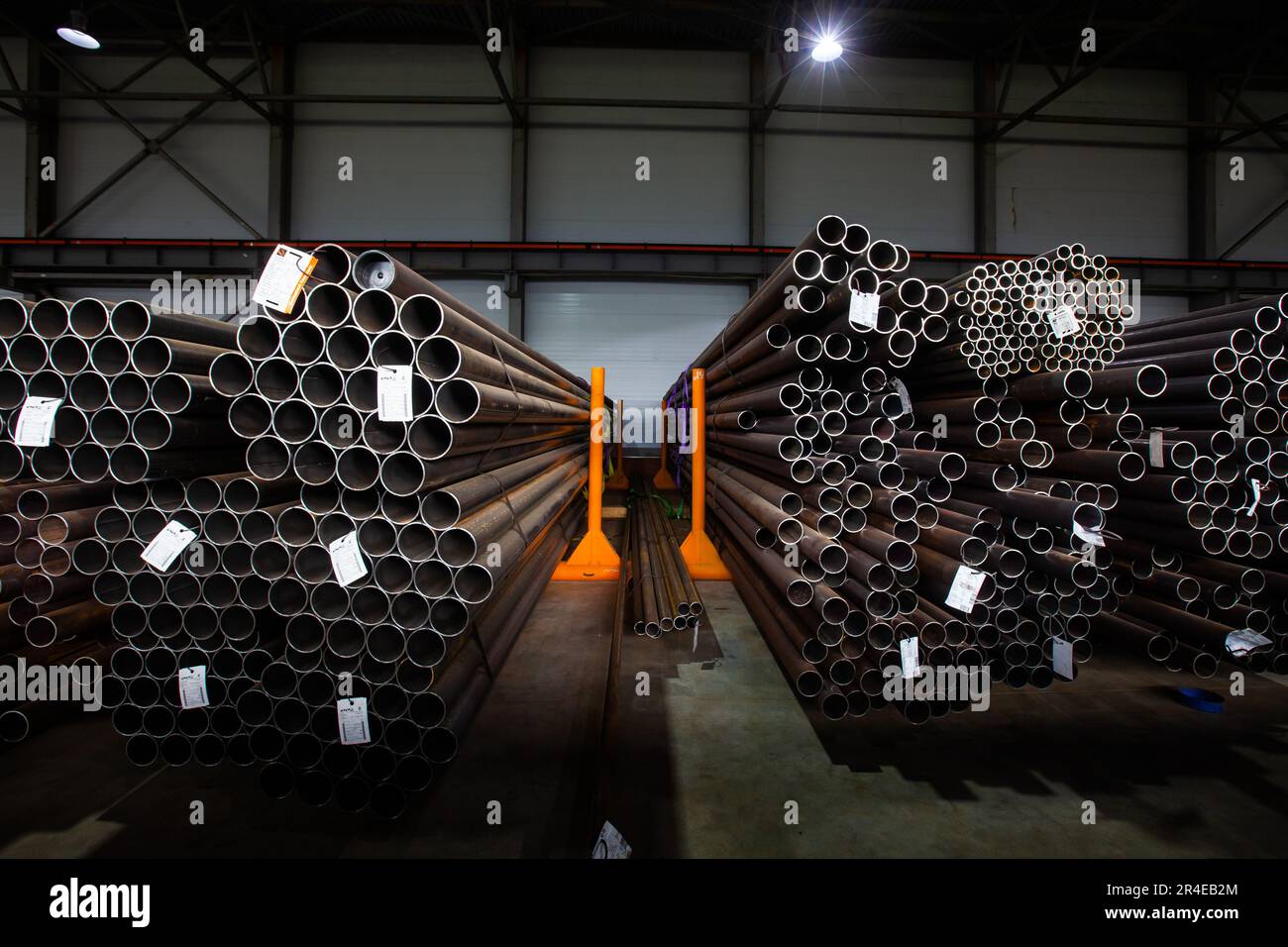 Pipes and tubes warehouse in metal hangar Stock Photo - Alamy