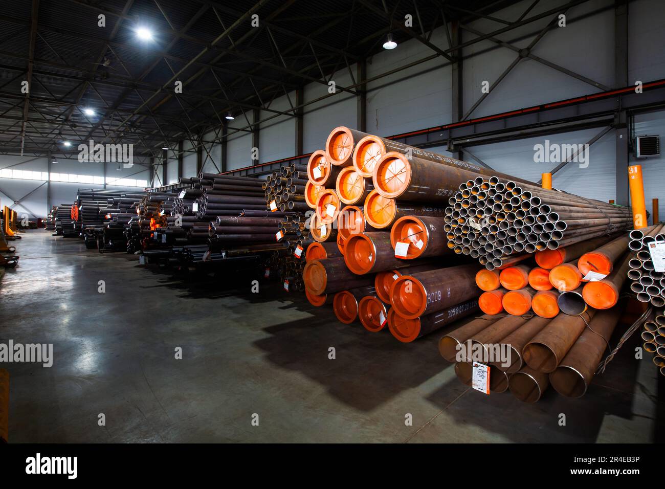 Pipes and tubes warehouse in metal hangar Stock Photo - Alamy