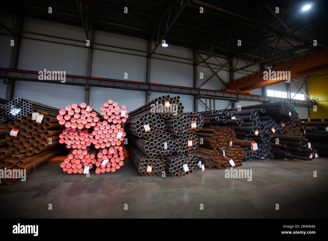 Pipes and tubes warehouse in metal hangar Stock Photo - Alamy