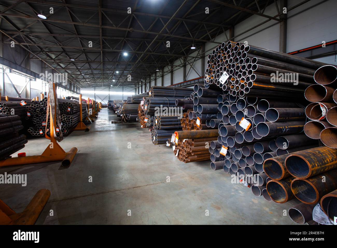 Pipes and tubes warehouse. Metal hangar, concrete floor Stock Photo - Alamy