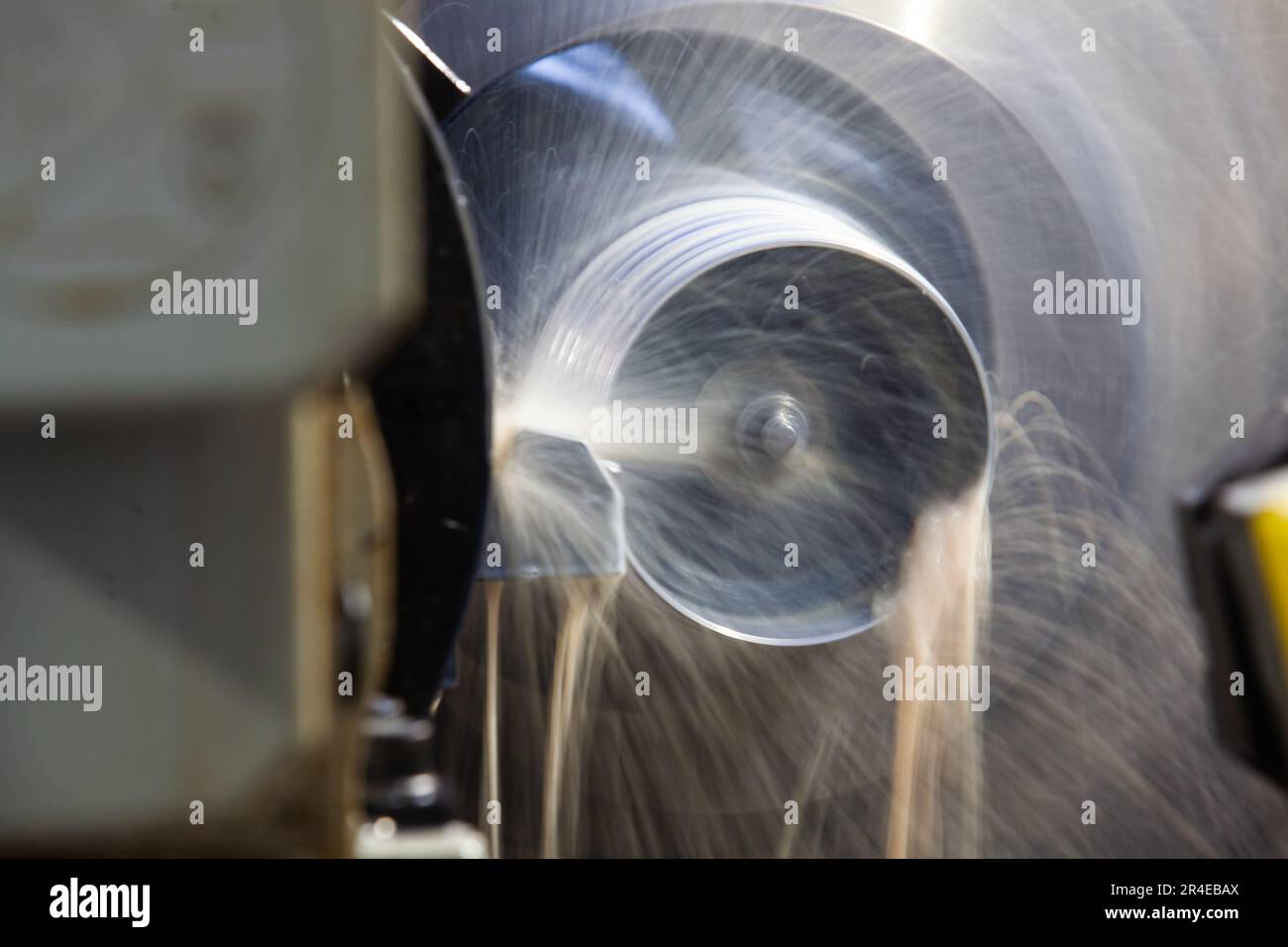 Machining pipe on turning lathe. Closeup photo. Water cooling of tool ...