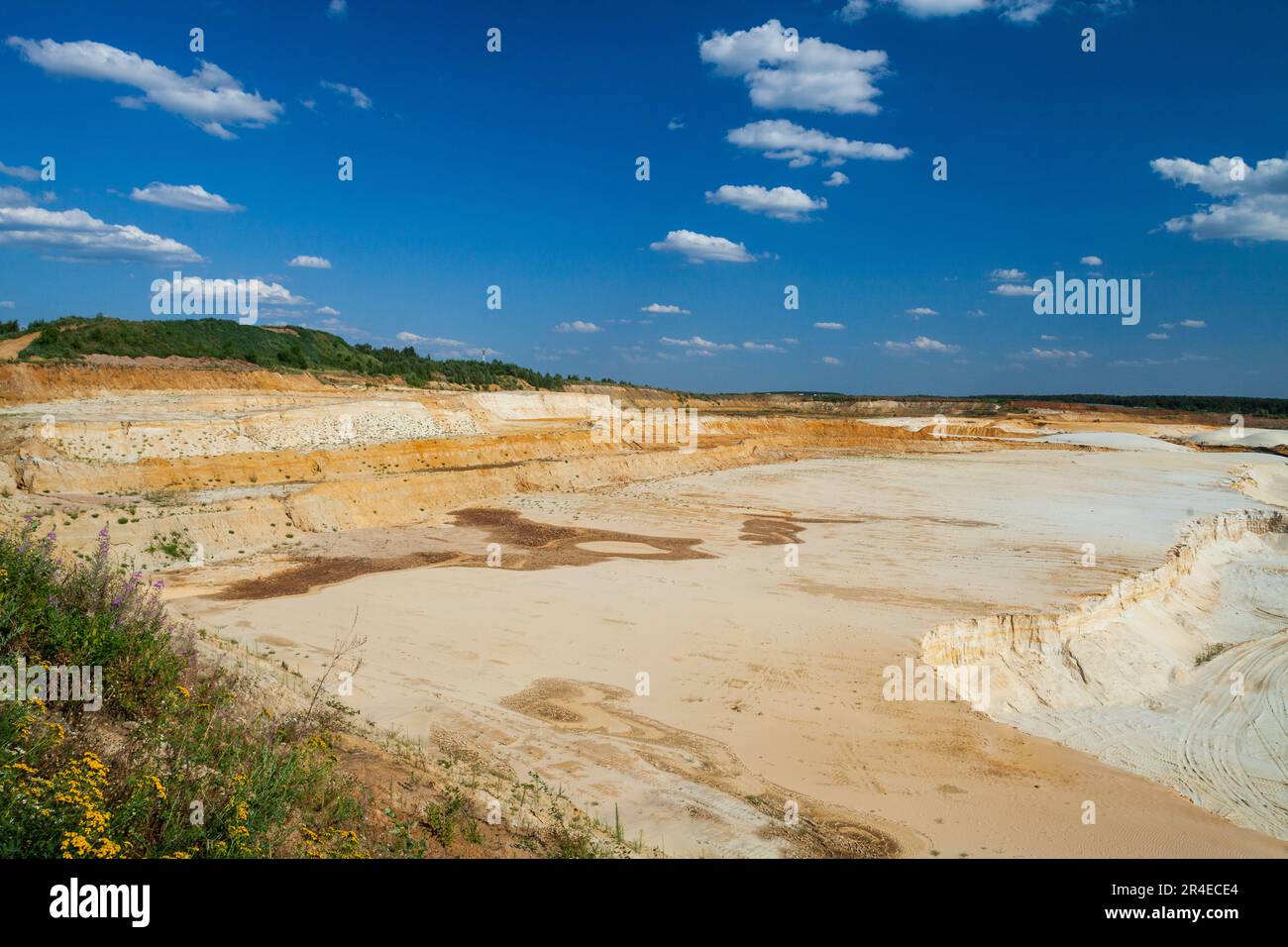 Panoramic view of white sand quarry against blue sky and clouds. Open ...