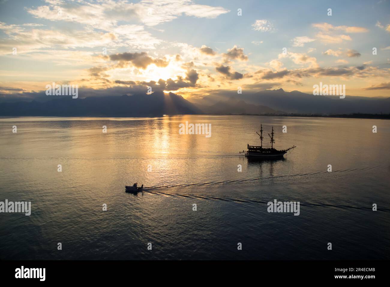 A stunning view of two sailing vessels in the open sea as the sun ...