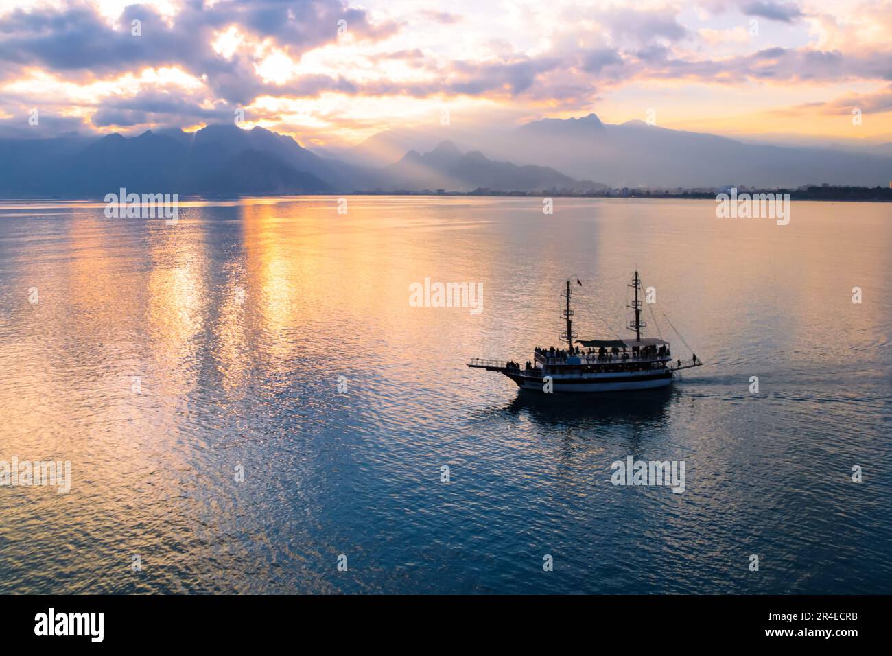 A single ship silhouetted against a beautiful sunset sky on the open ...