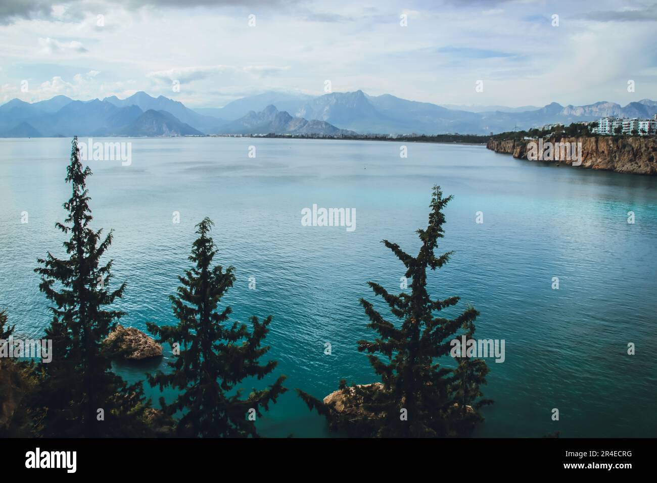 A stunning landscape featuring majestic mountain peaks towering over a ...