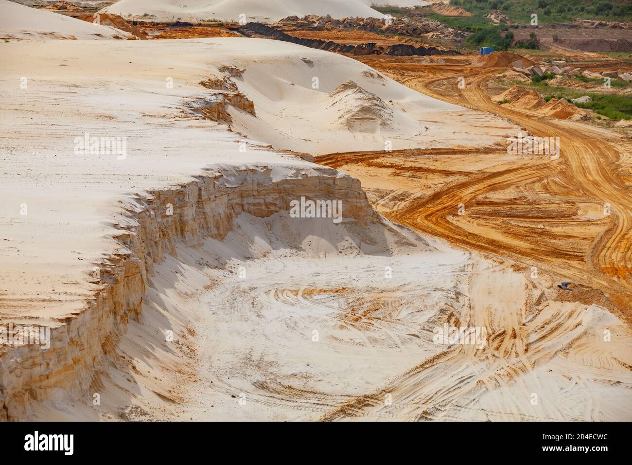 White sand texture in quarry. Open-pit extraction. Car tracks right ...
