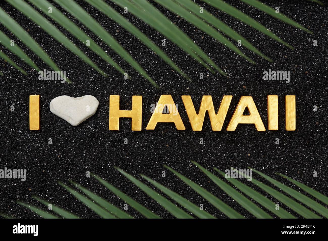 I Love Hawaii - Text in the black beach sand and palm leaves Stock ...