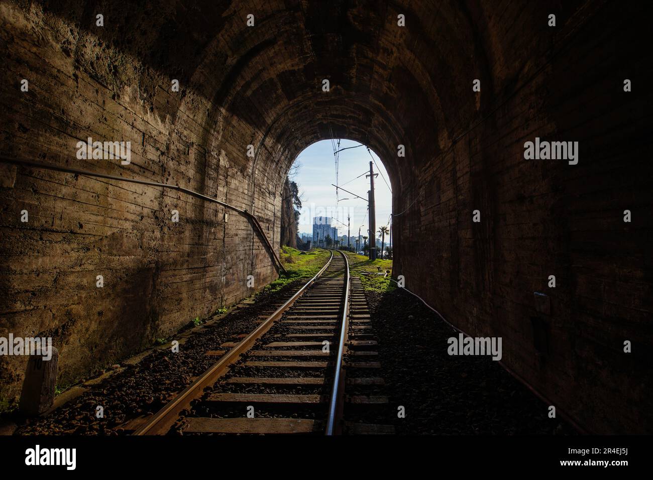 Light at the end of railroad tunnel Stock Photo - Alamy