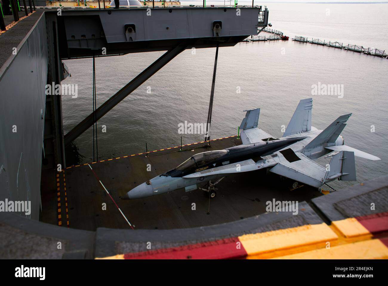 An F/A-18C Hornet, training aircraft is prepped to be elevated to the ...