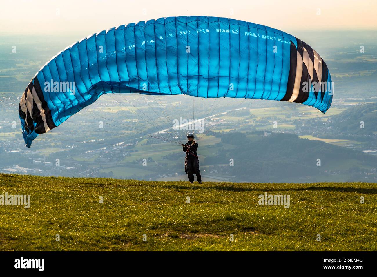 Paraglider taking off on the Goasnalm high above Salzburg, Austria ...