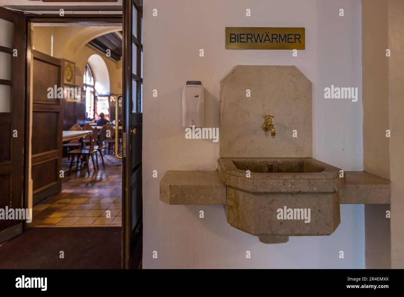 Wall basin with hot water and the sign "Beer Warmer". The beer is ...