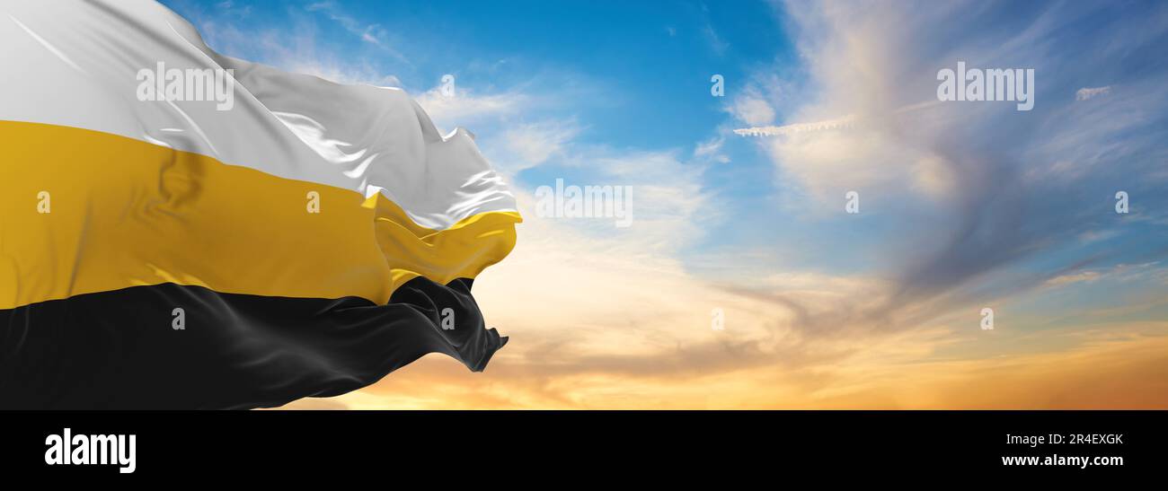 official flag of Perak Malaysia at cloudy sky background on sunset ...