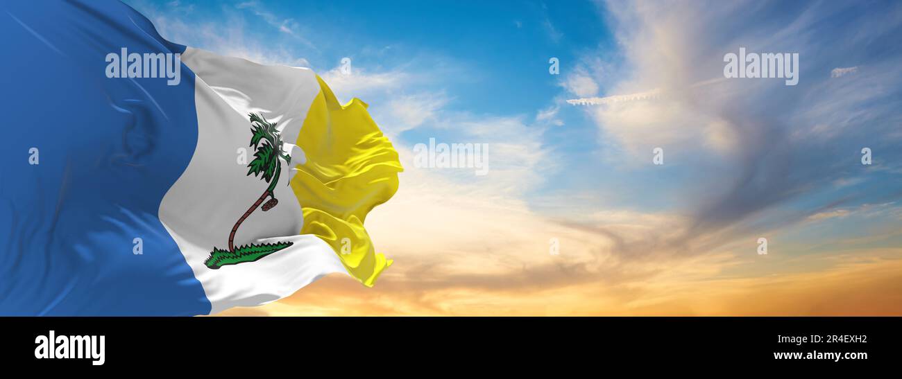 official flag of Penang Malaysia at cloudy sky background on sunset ...