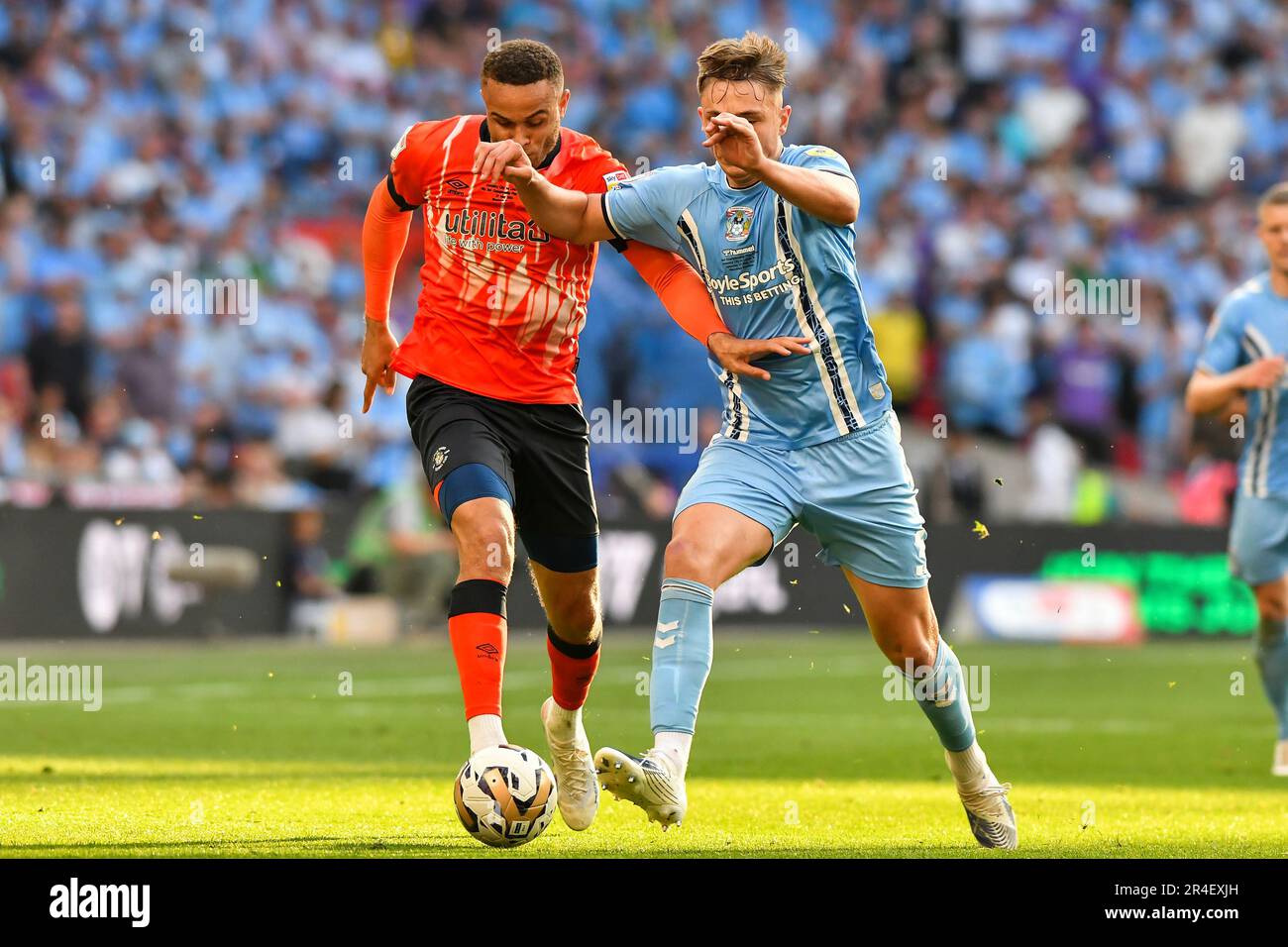 Carlton Morris of Luton Town battles for possession with Callum Doyle ...