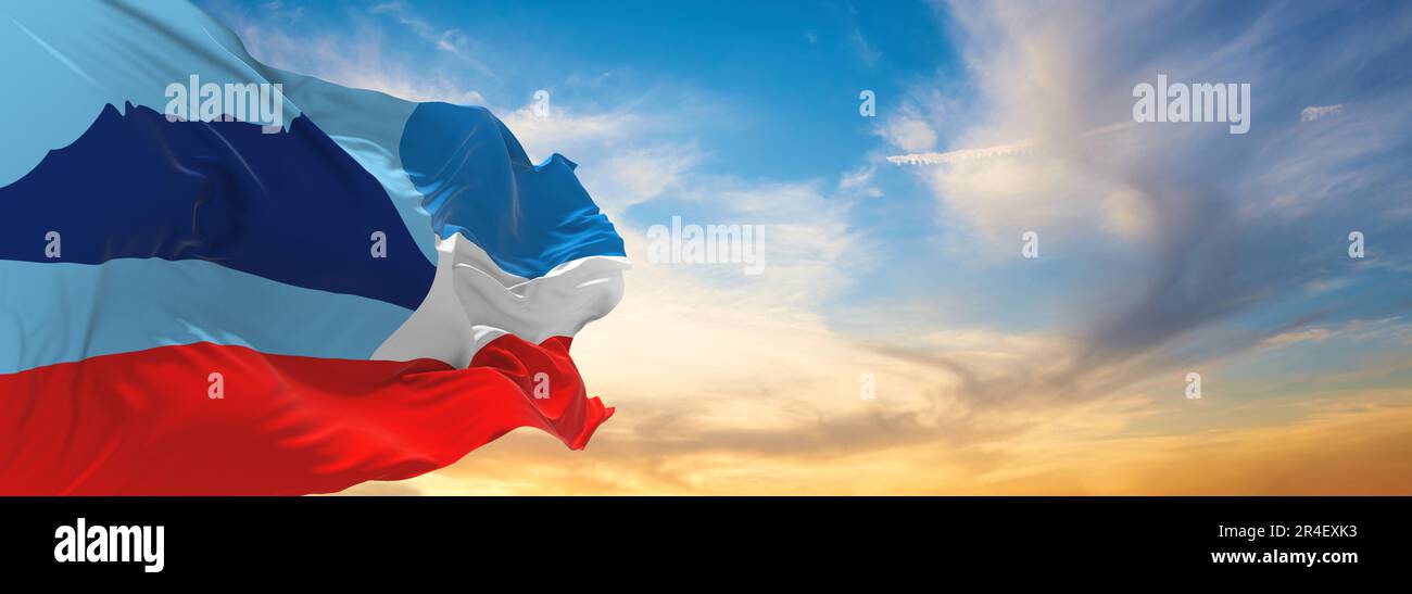 official flag of Sabah Malaysia at cloudy sky background on sunset ...