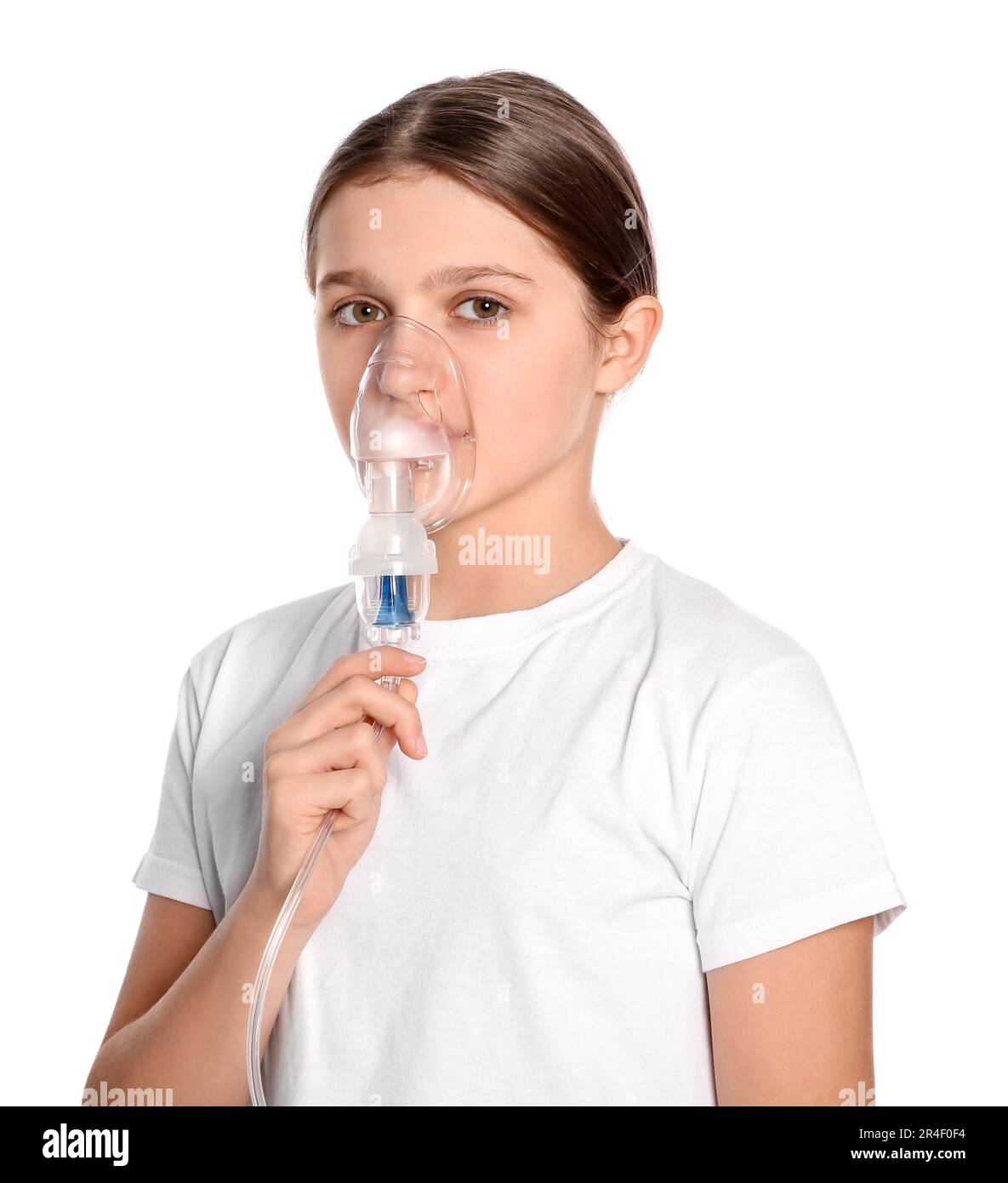 Cute girl using nebulizer for inhalation on white background Stock ...