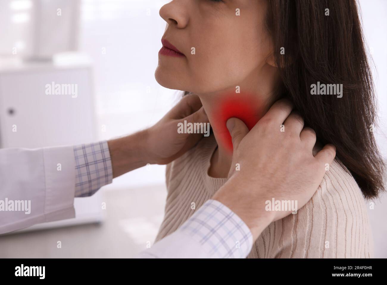 Endocrine system. Doctor examining patient's thyroid gland in hospital ...