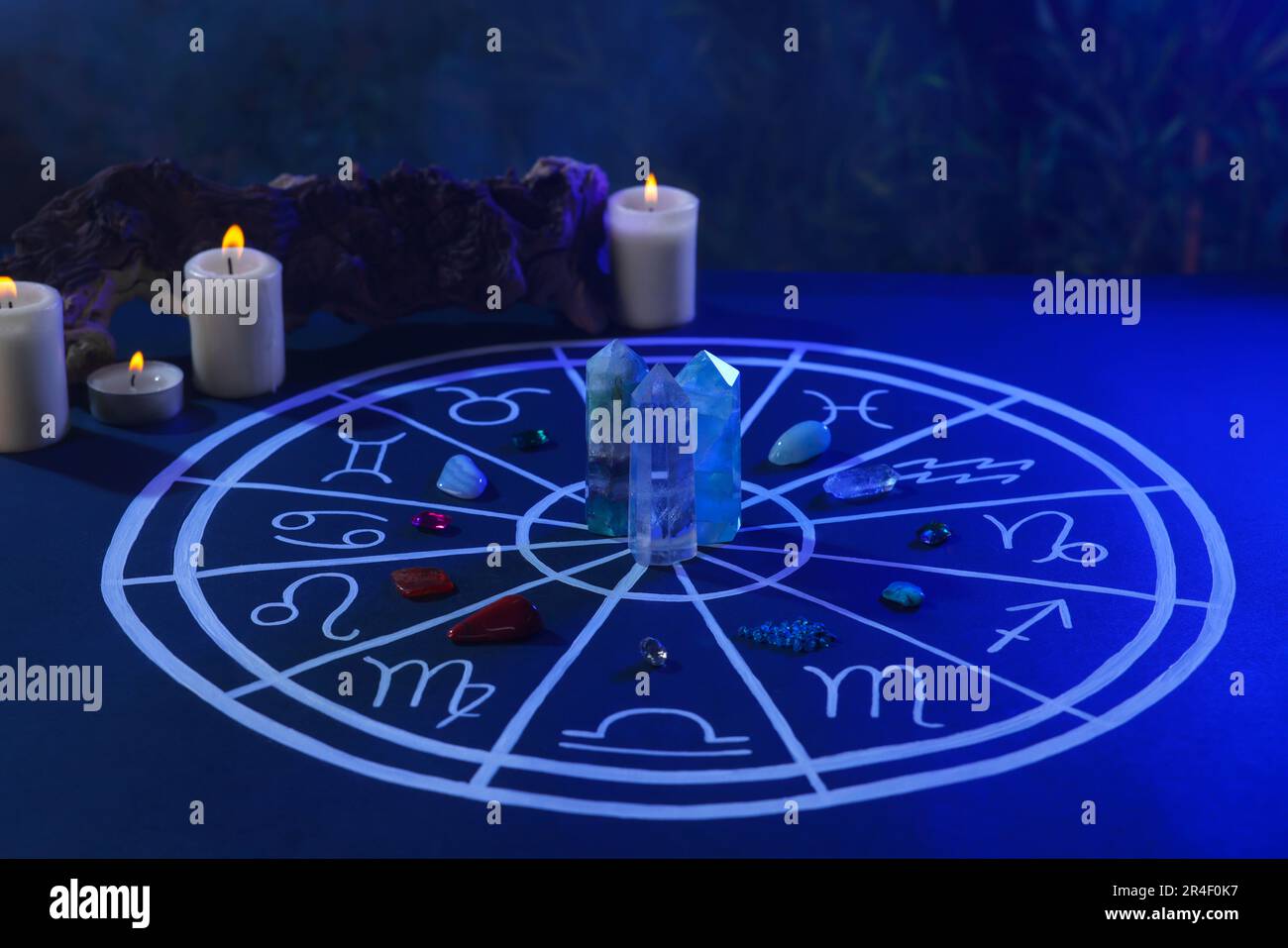 Natural stones for zodiac signs, drawn astrology chart and burning ...