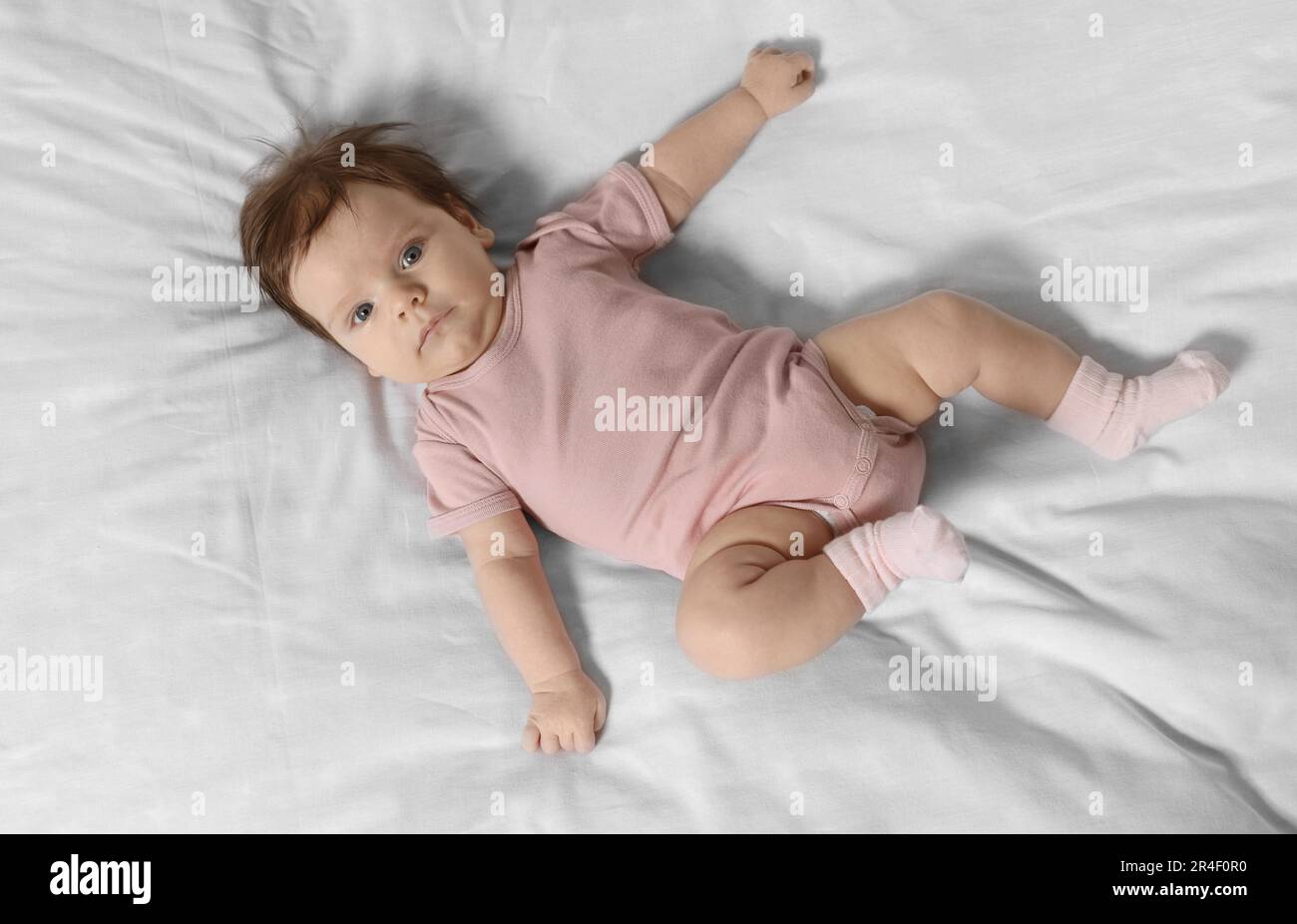 Cute little baby on cosy bed, top view Stock Photo - Alamy