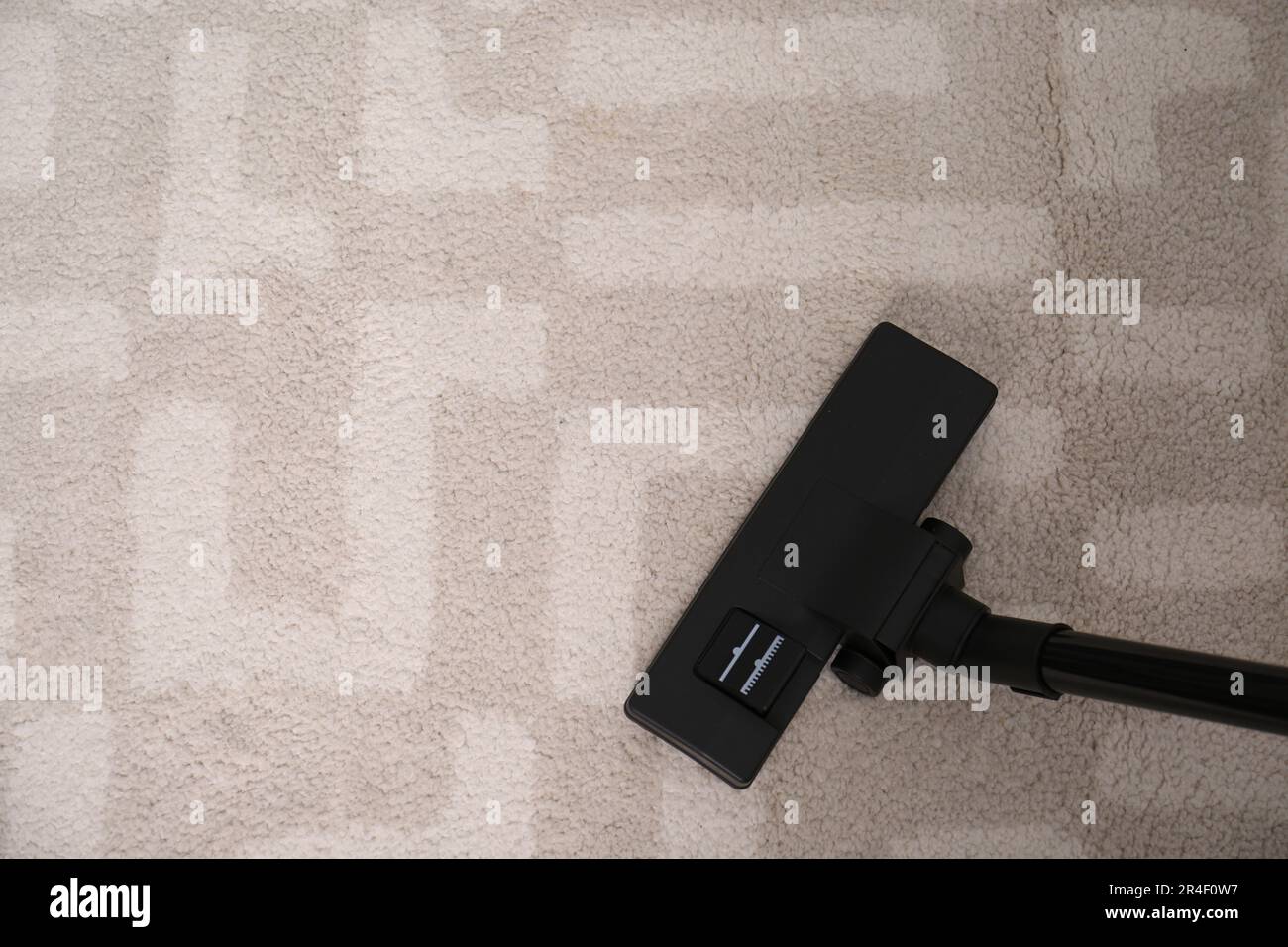 Hoovering floor with modern vacuum cleaner, top view. Space for text ...