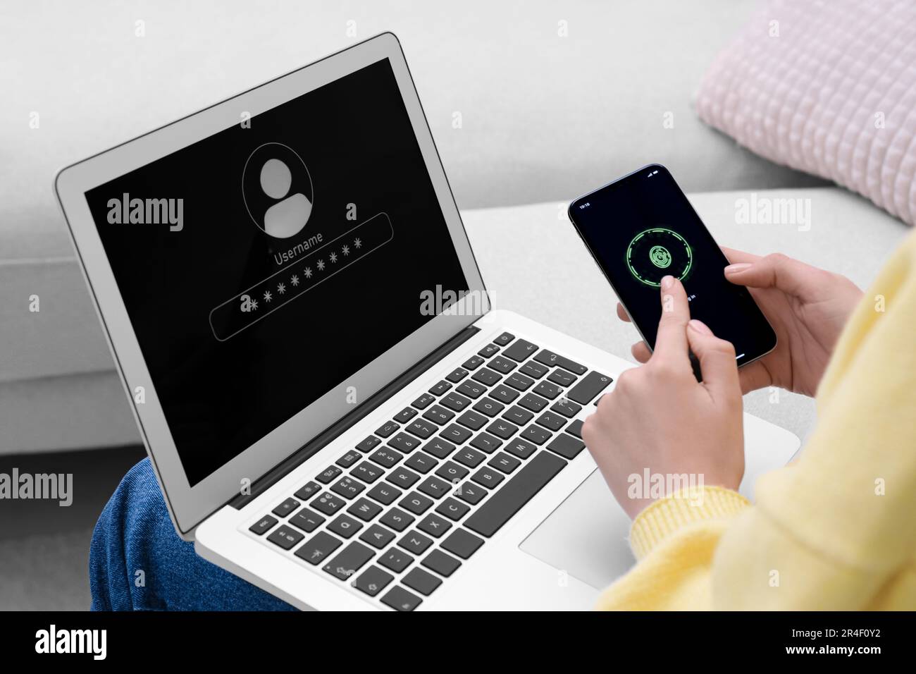 Woman unlocking smartphone with fingerprint scanner, closeup. Her ...