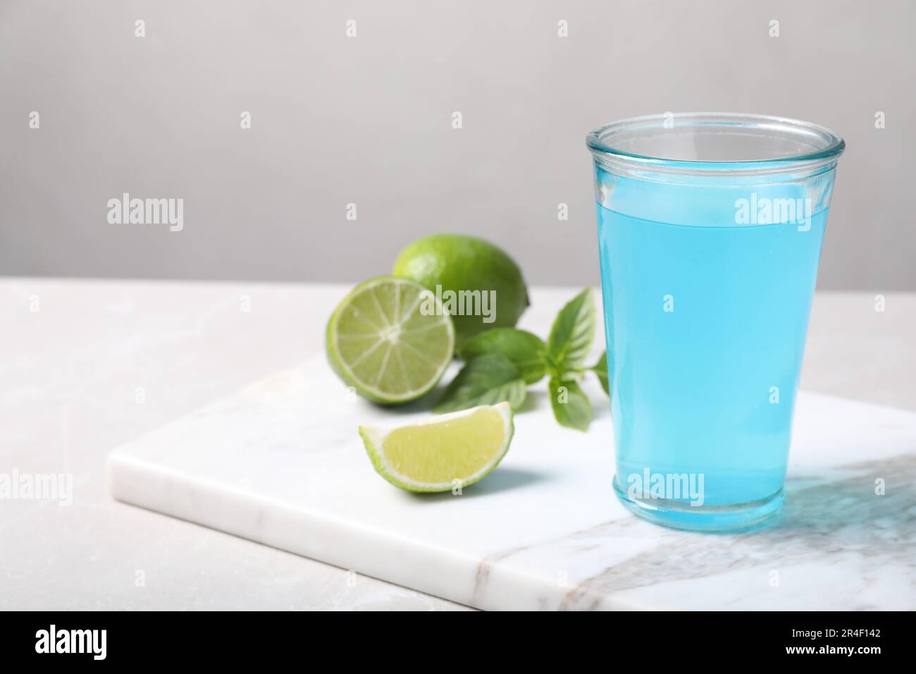 Refreshing light blue drink on white table, space for text Stock Photo ...