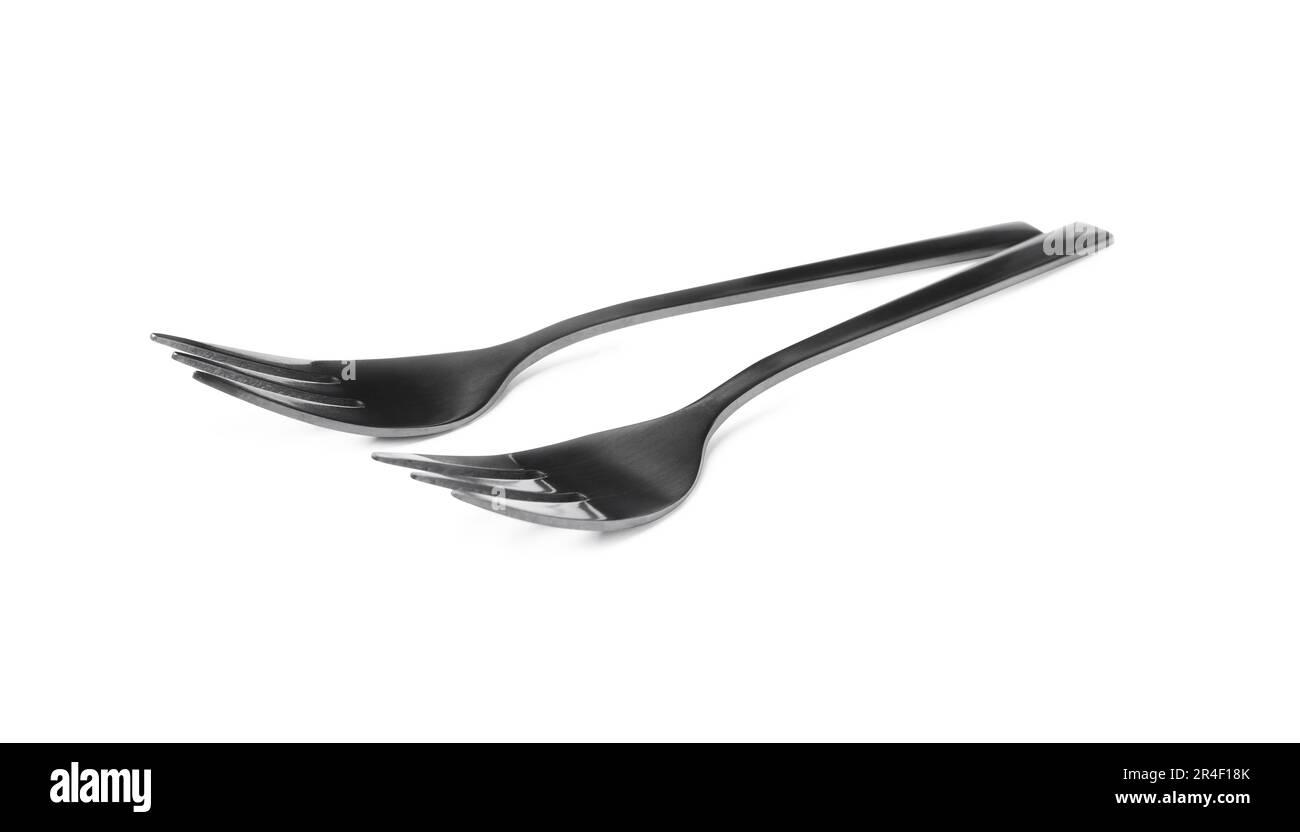 Clean shiny metal forks on white background Stock Photo - Alamy