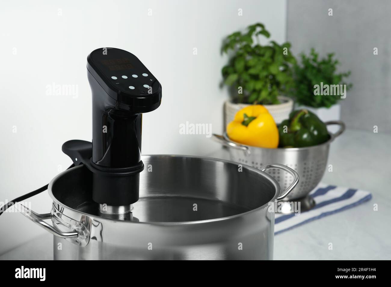 Pot with sous vide cooker in kitchen, closeup. Thermal immersion ...