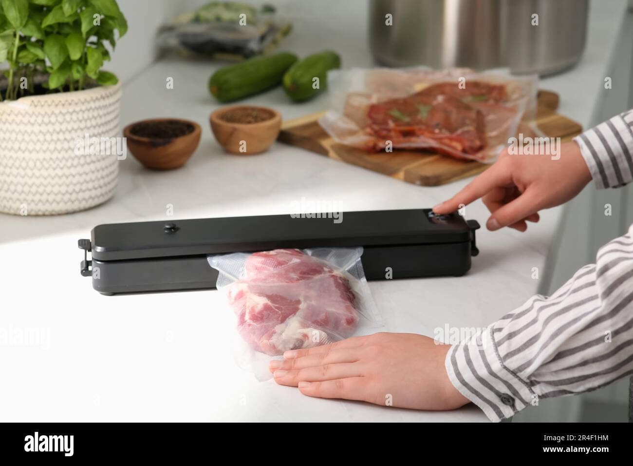 Hands using vacuum sealer hi-res stock photography and images - Alamy