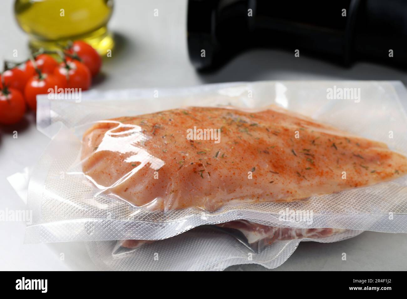 Vacuum packing with meat on white table, closeup. Sous vide cooking ...
