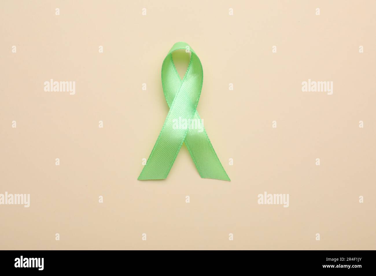 World Mental Health Day. Green ribbon on color background, top view ...