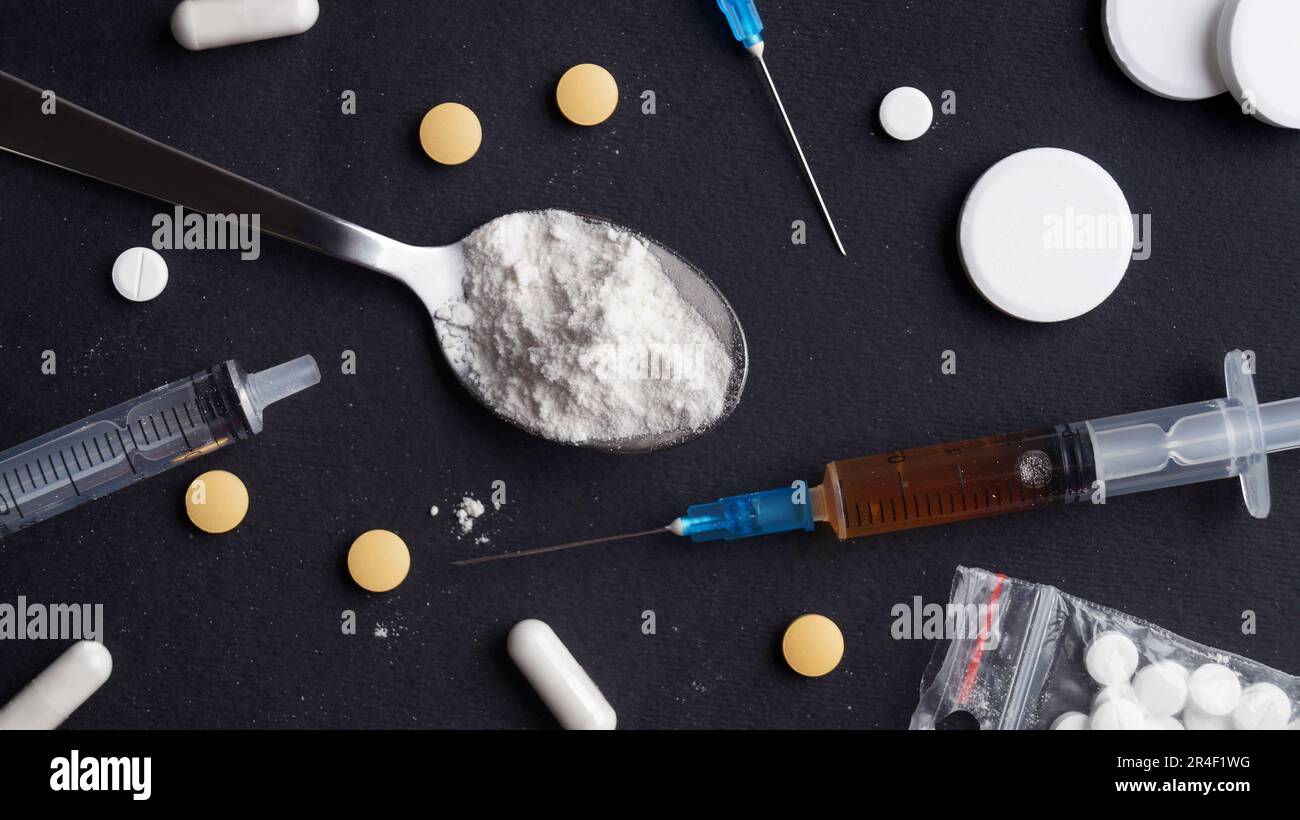 Different hard drugs on black background, flat lay Stock Photo - Alamy
