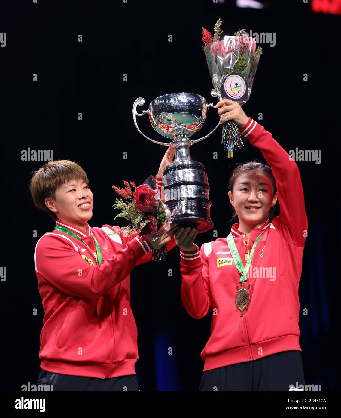 Chen Meng and WANG Yidi of China celebrate during an award ceremony of women's doubles in 2023 ...