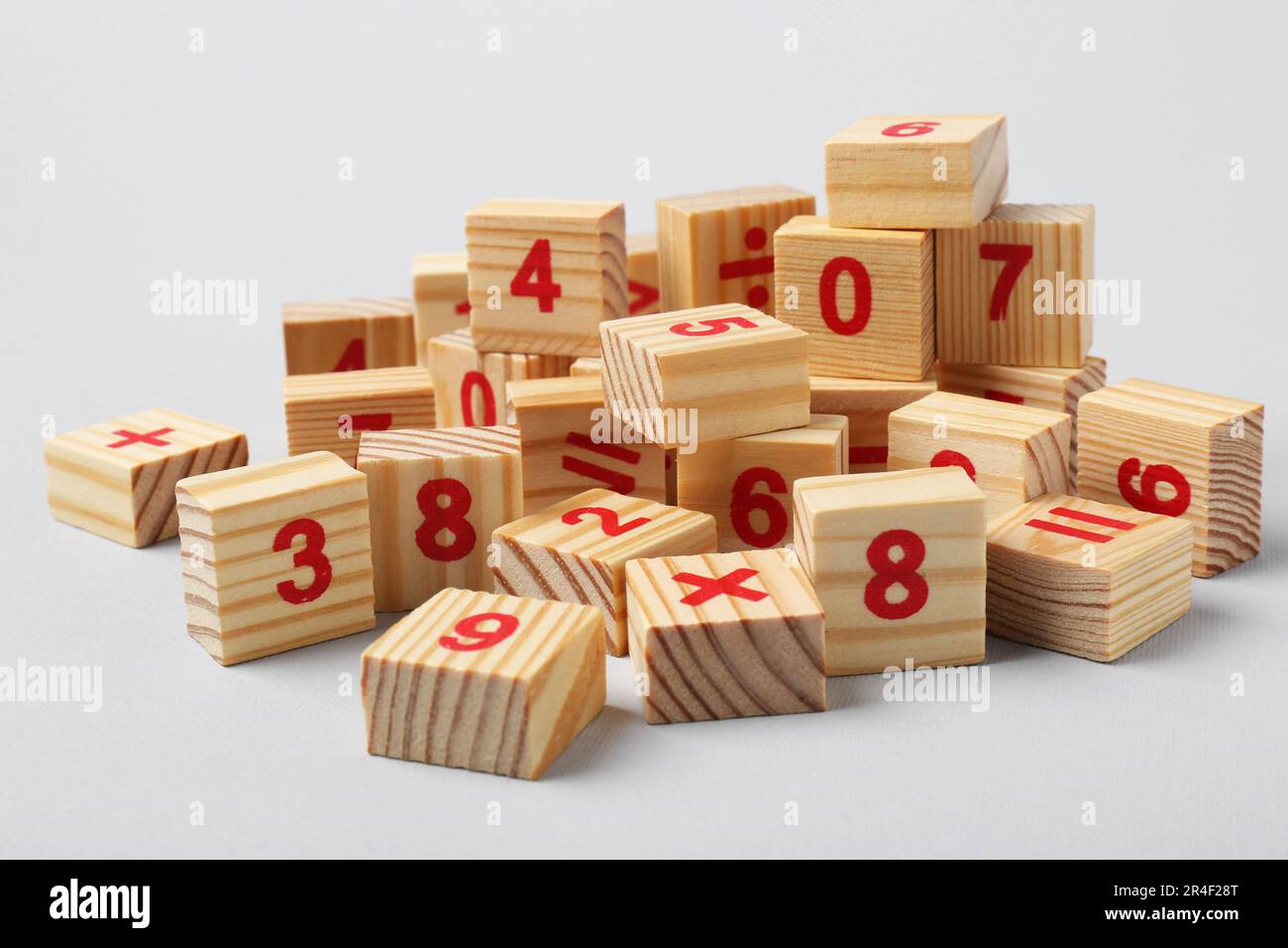 Wooden cubes with numbers and mathematical symbols on light background ...
