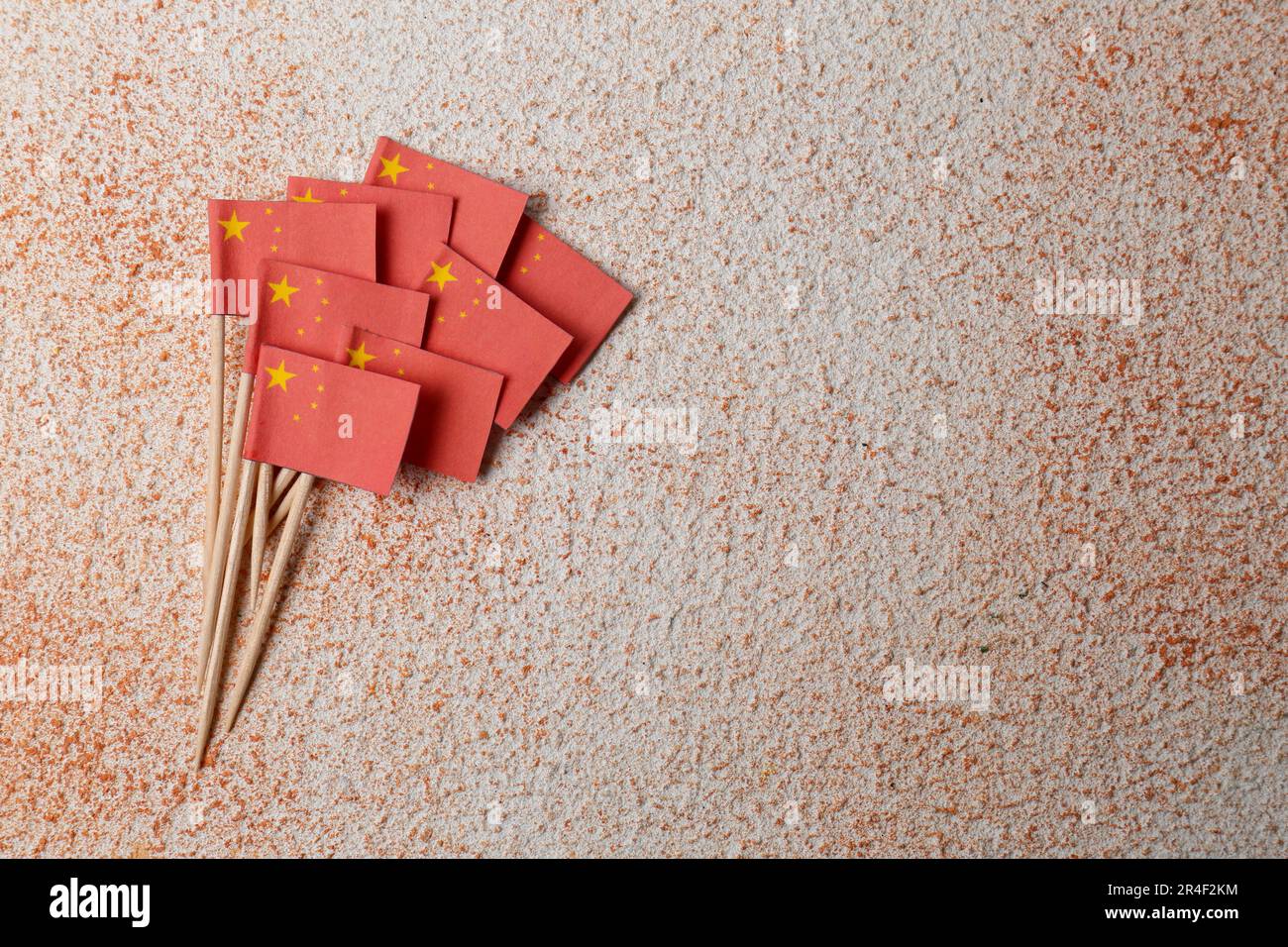 Small paper flags of China on color textured background, flat lay ...
