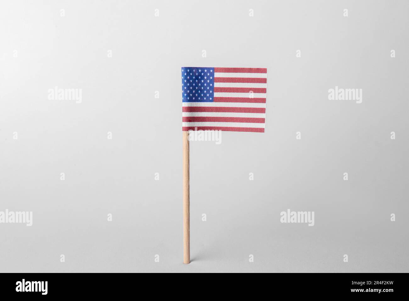Small paper flag of USA on light background. Space for text Stock Photo ...