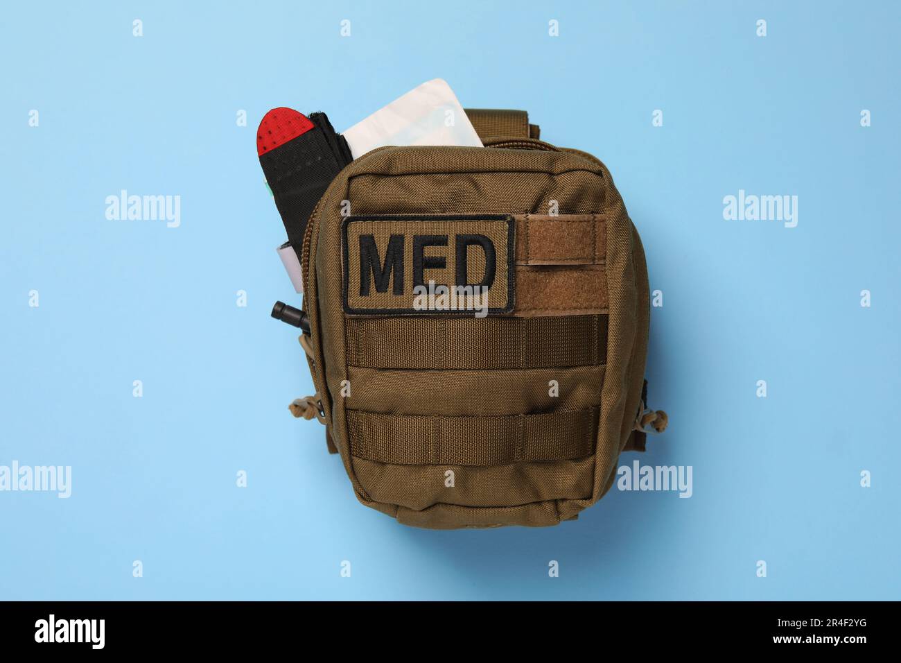 Military first aid kit on light blue background, top view Stock Photo ...
